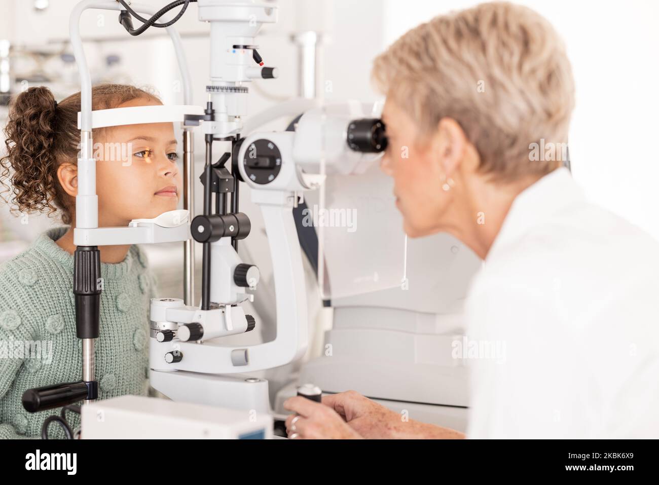 Optometry, vision and optometrist doing eye test on girl for optical ...