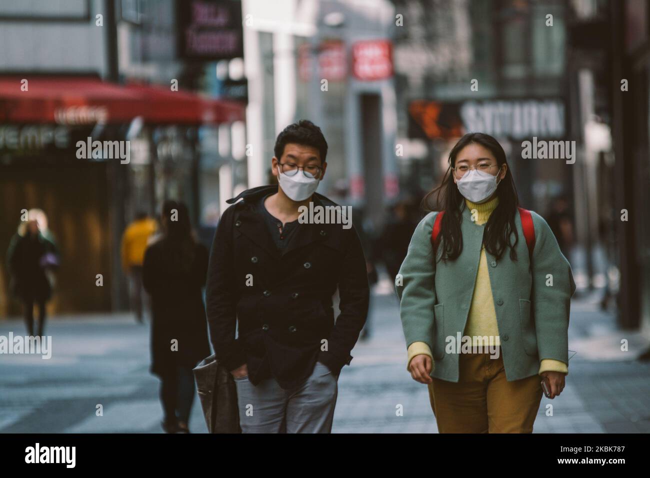 People wearing a face mask in Cologne, Germany, on March 18, 2020 ...