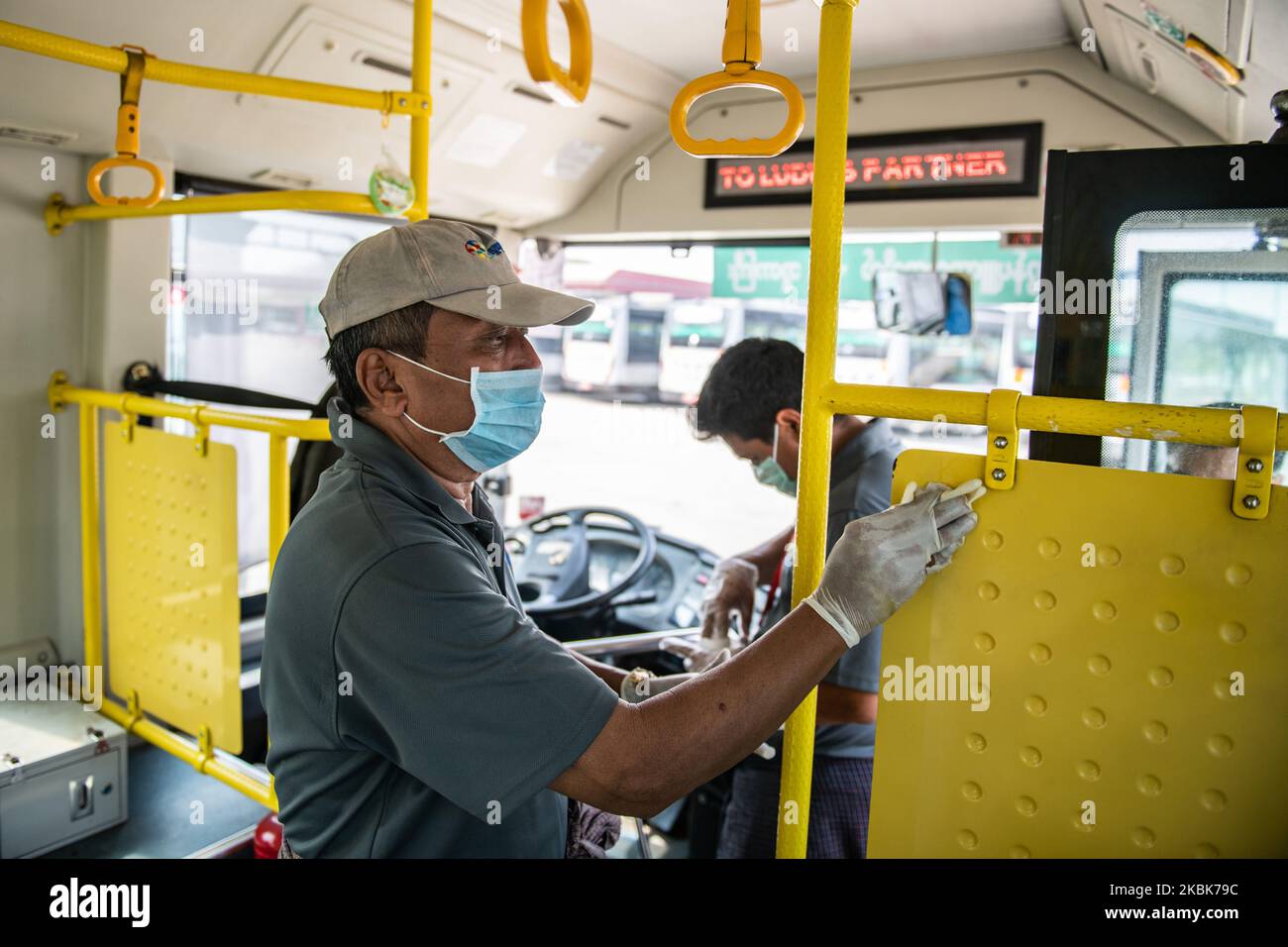 A staff disinfects a bus, amid concerns of the COVID-19 coronavirus, in ...