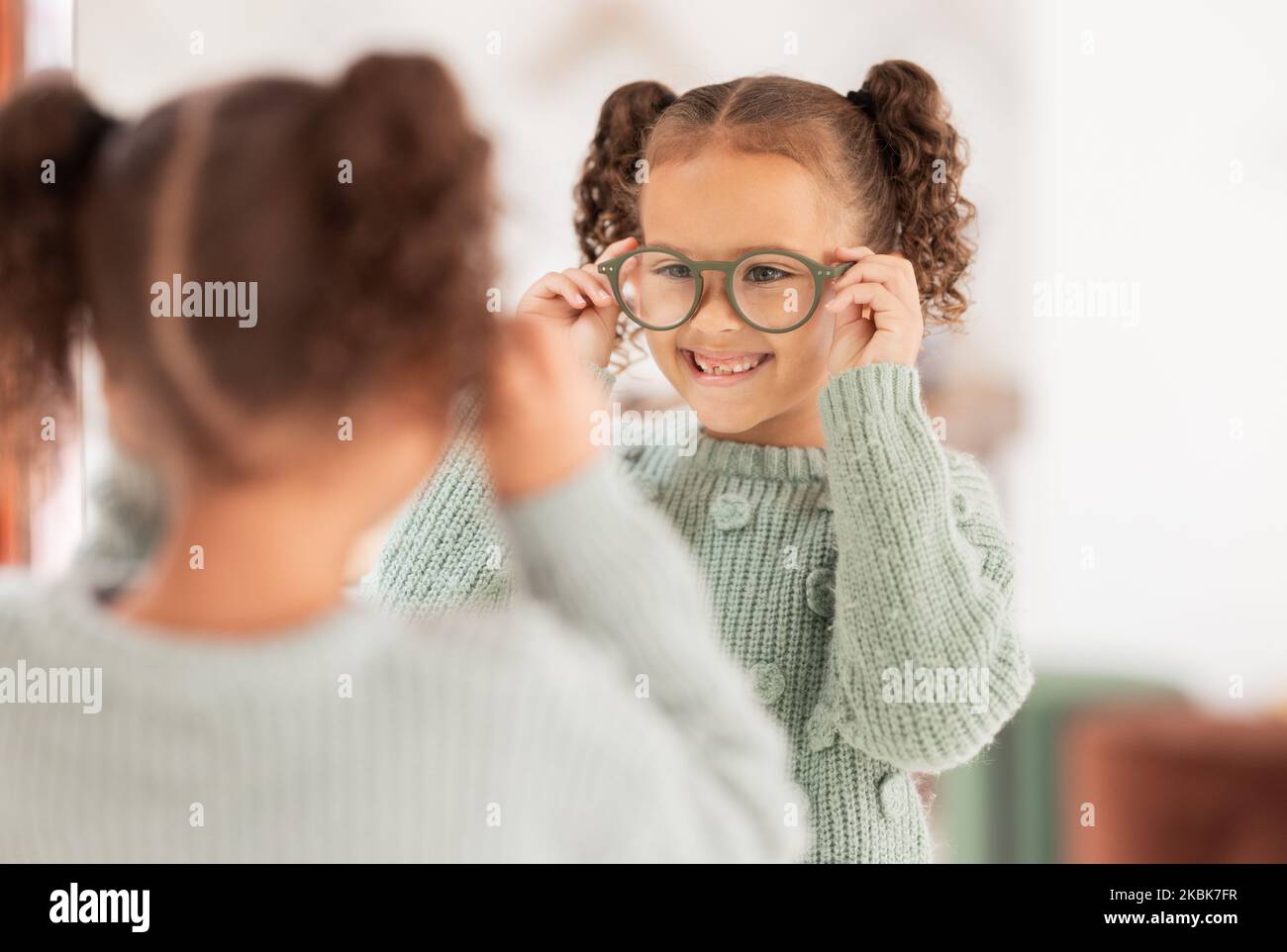 Children, mirror and girl with glasses at optometry store, testing or ...