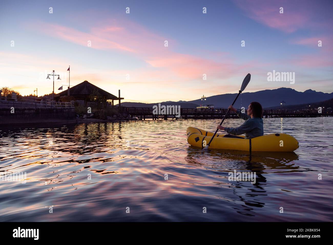 Adventurous Woman Kayaking on an Inflatable Kayak in the Pacific Ocean ...