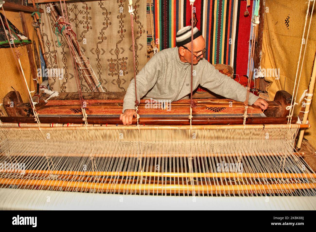 Man weaving a carpet on a loom using Agave silk in Chefchaouen, Morocco ...