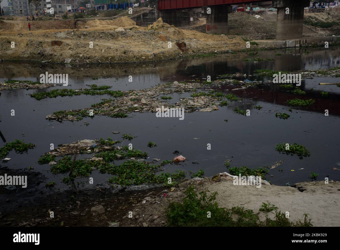 Waste water flows from the city drain into the Turag River in Dhaka ...