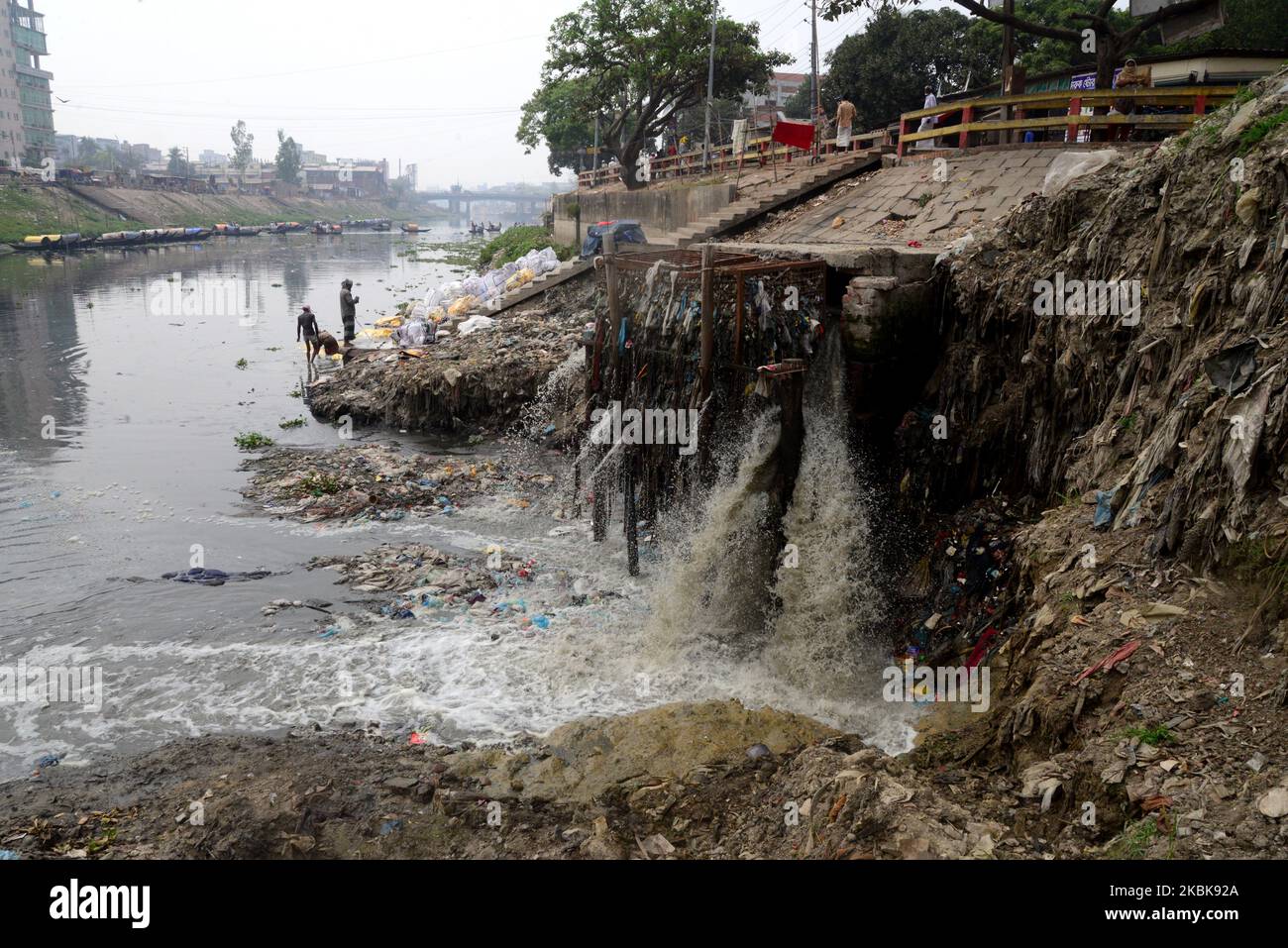 Waste water flows from the city drain into the Turag River in Dhaka ...