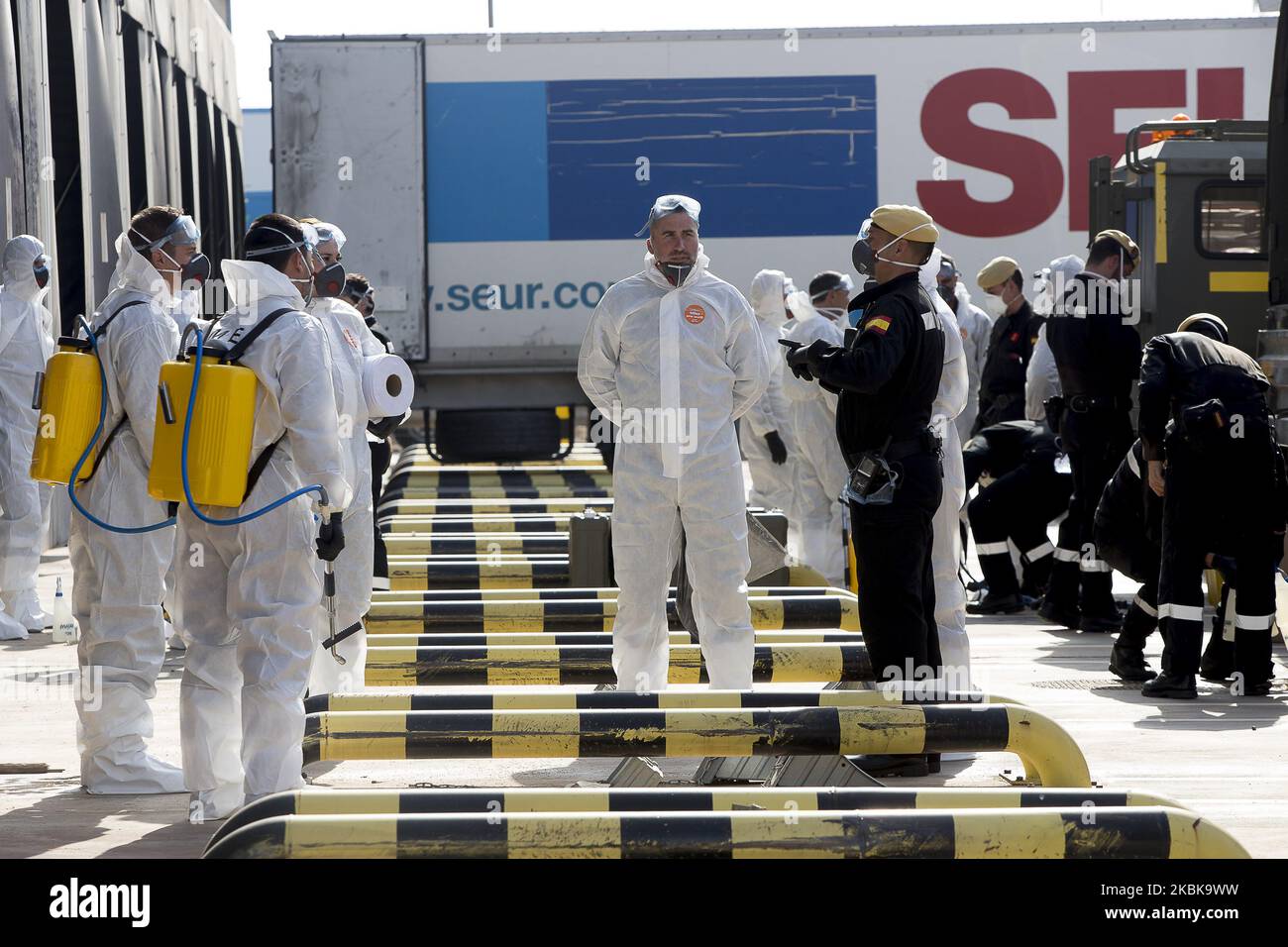 Members of the Spanish Army's UME (Military Emergency Unit) disinfect ...