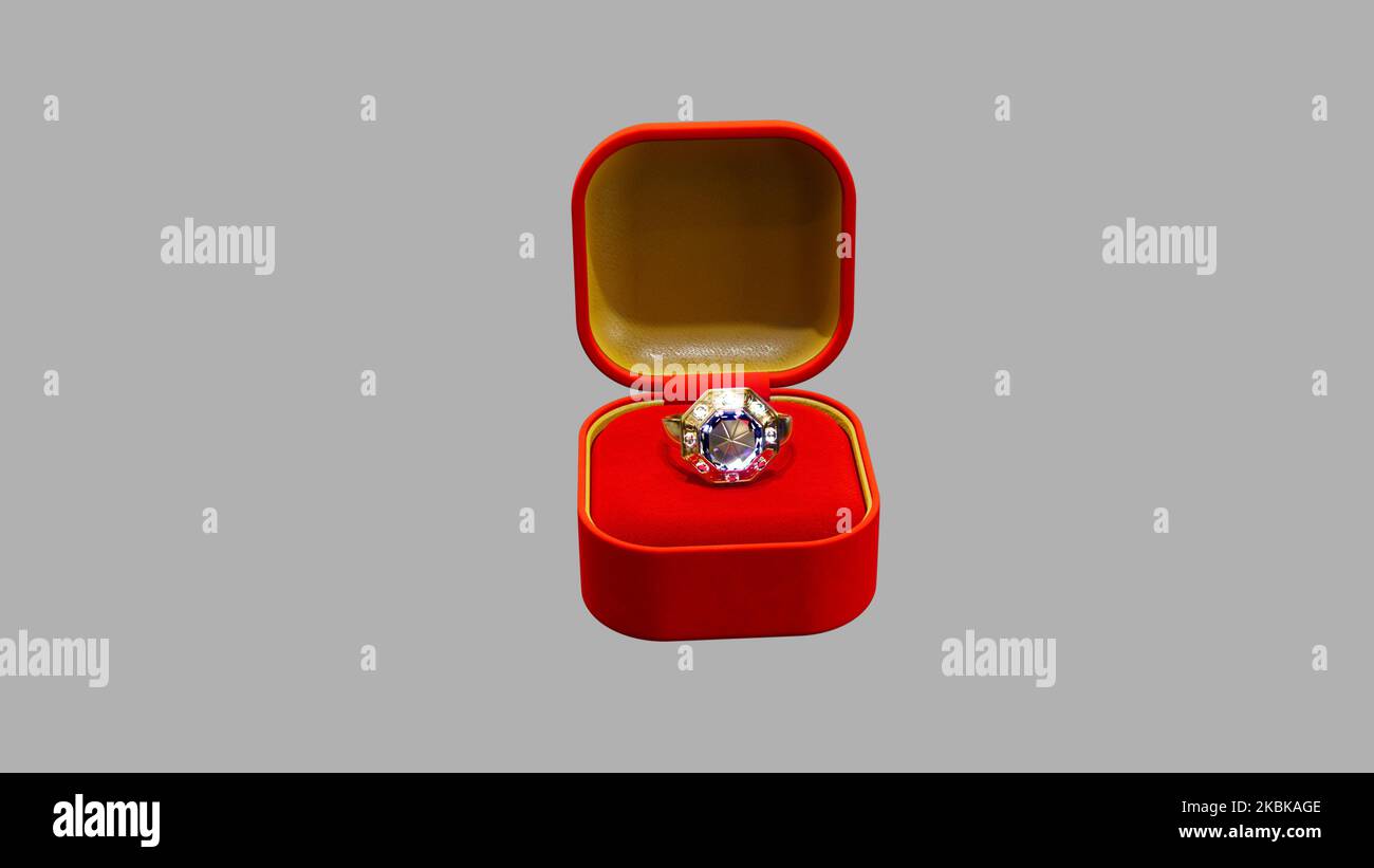 Red - golden opened jewellery present box with diamond wedding ring on ...