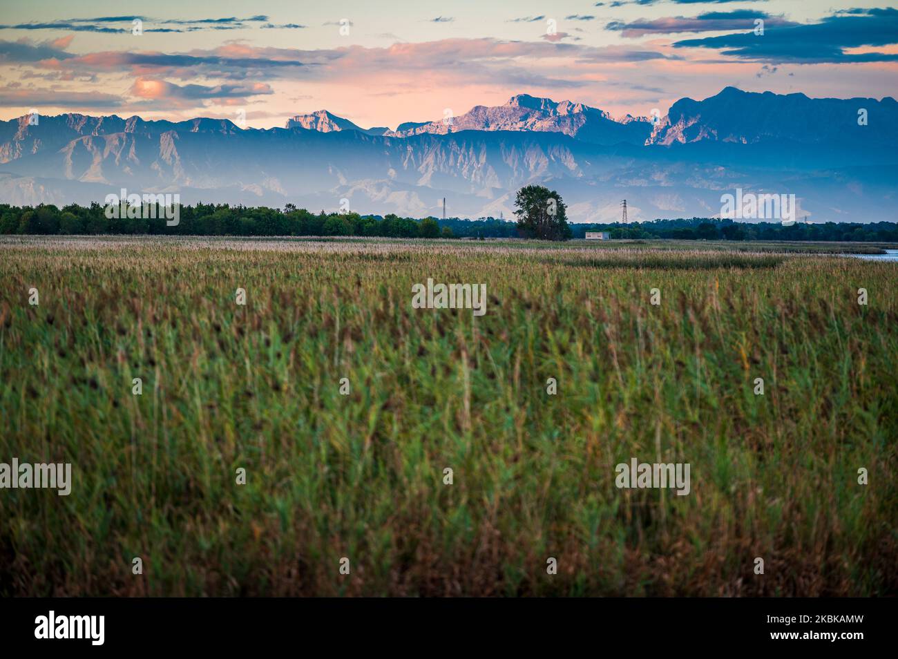 Towards the sunset. Marano lagoon late summer colors. Clouds and sun ...