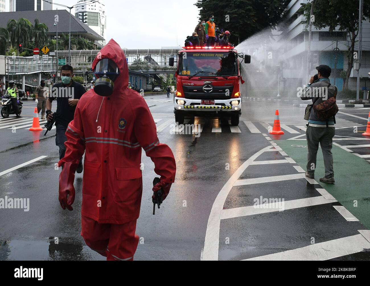 Firefighters spray disinfectant liquid in the Bundaran Hotel Indonesia ...