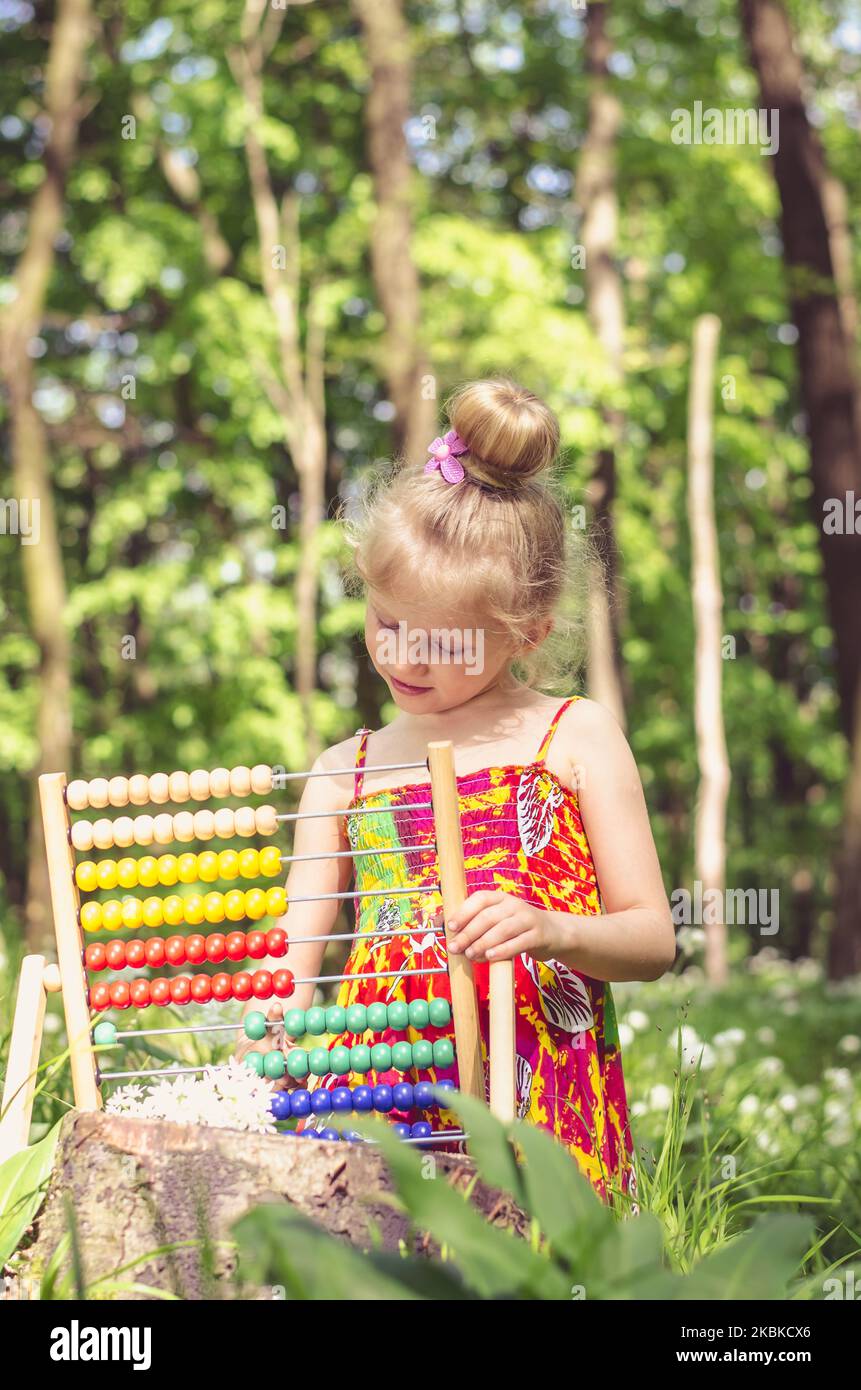 little preschool kid learning maths with use of abacus Stock Photo - Alamy