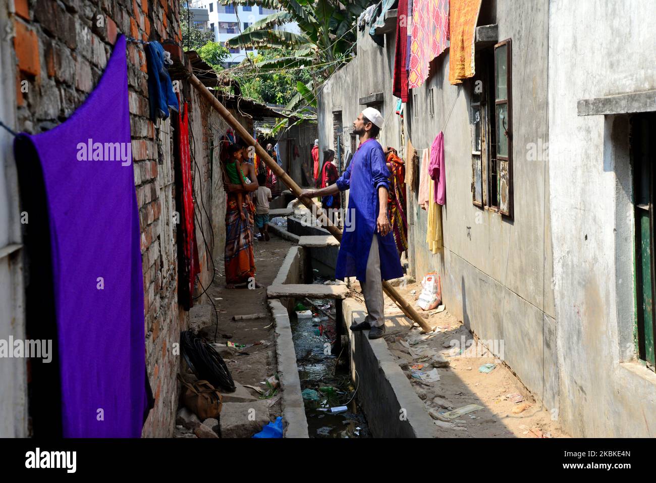 Bangladesh slum peoples walks on the narrow lane at a Mirpur Slum in ...