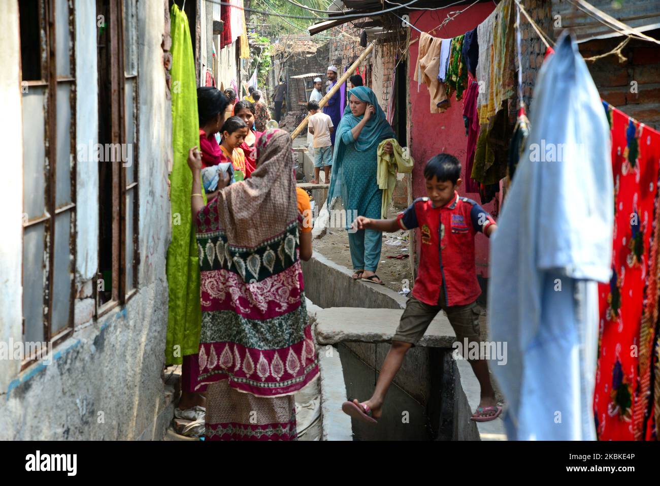 Bangladesh slum peoples walks on the narrow lane at a Mirpur Slum in ...