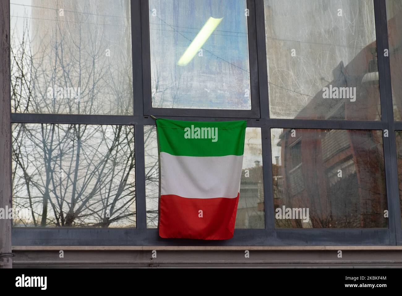 An Italian flag is showed in solidarity with to efforts to curb the ...