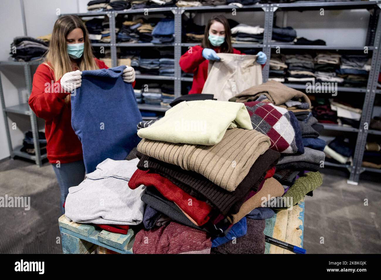 Red Cross members fold clothes at a temporary hospital for vulnerable ...