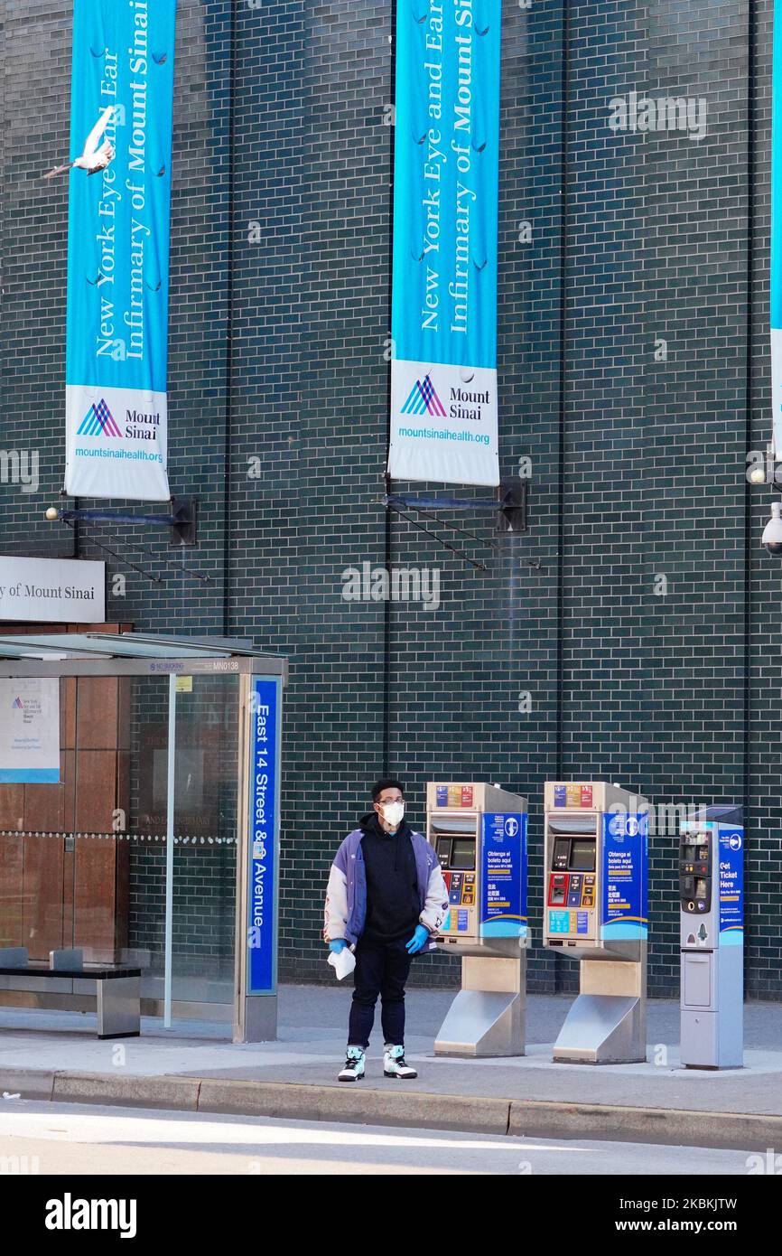 A view of a person wearing mask on a bus stop amid the coronavirus ...