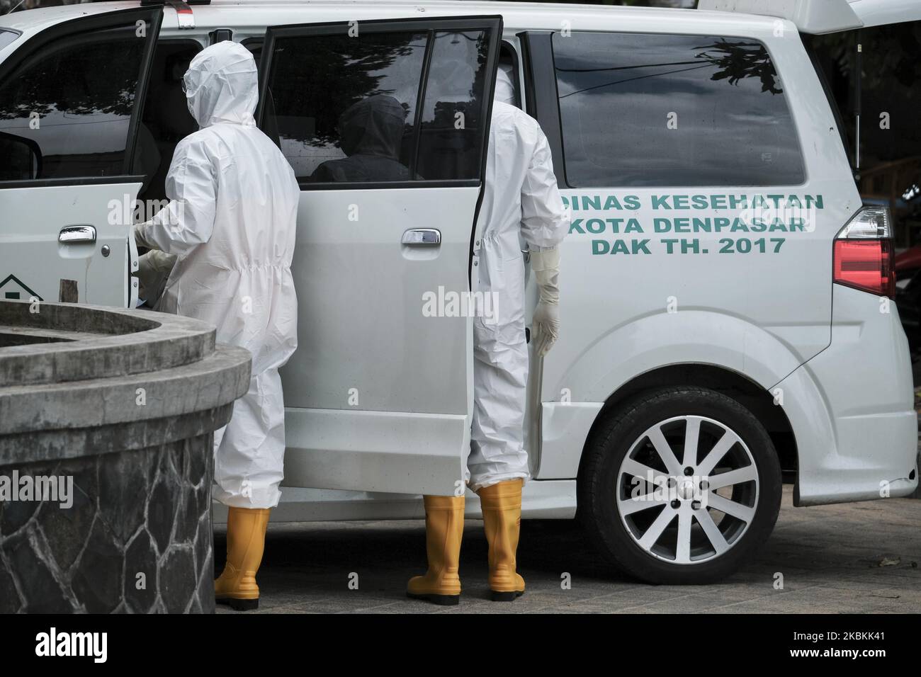 Medical team wearing a protective clothes as they evacuated a sick ...