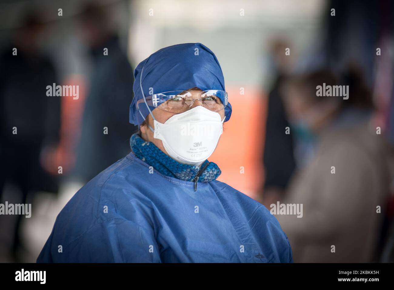 The hospital worker wearing a mask and protective equipment in a tent ...