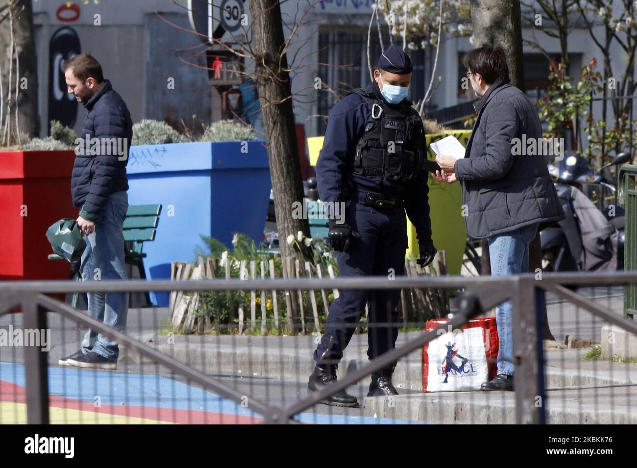 Policeman with a protective mask carrying out checks on people in Paris ...