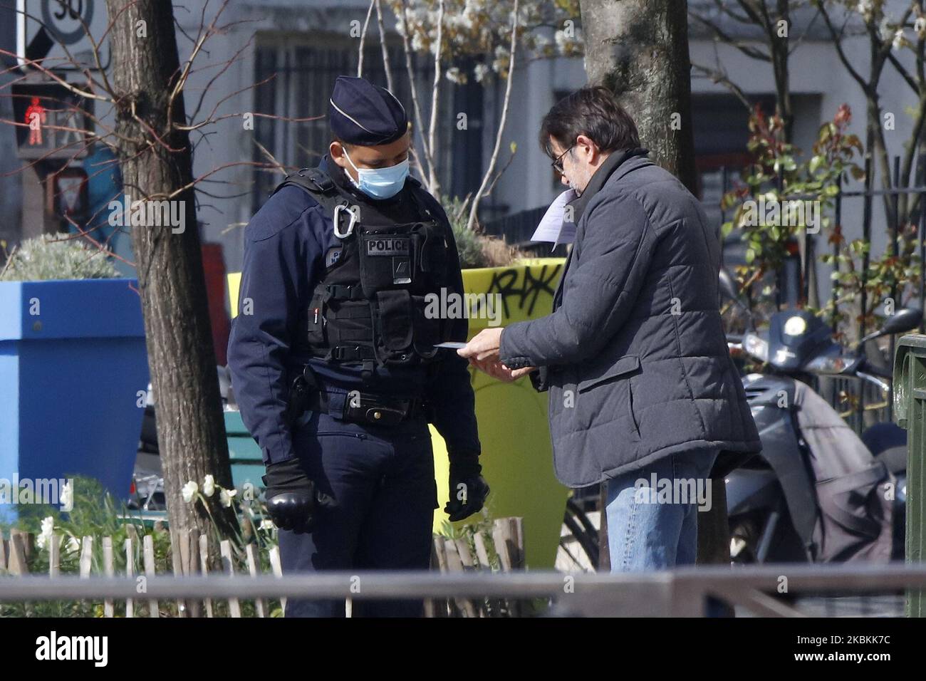 Policeman with a protective mask carrying out checks on people in Paris ...