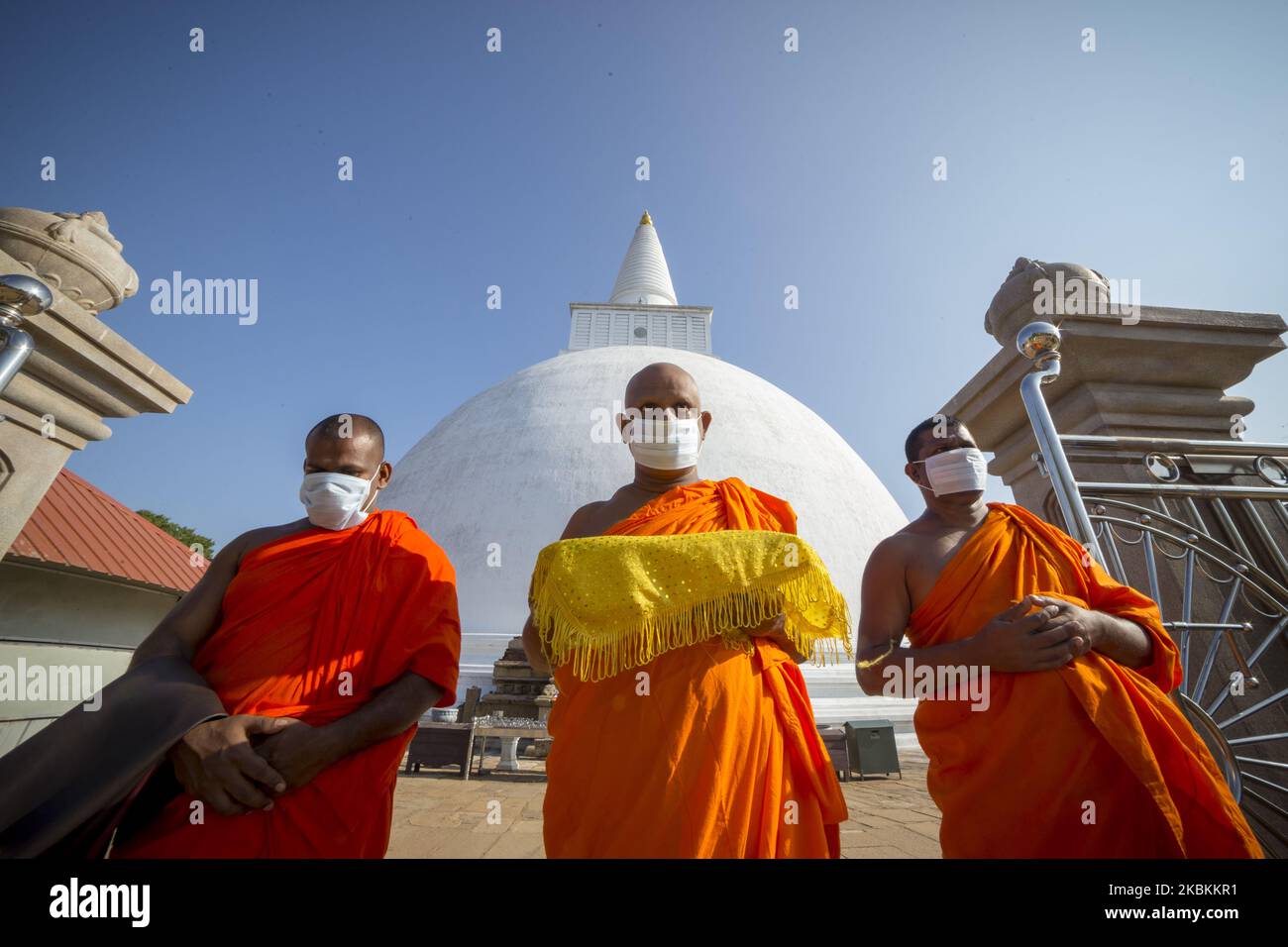 Sri Lankan Buddhist monks wearing protective face masks perform rituals ...
