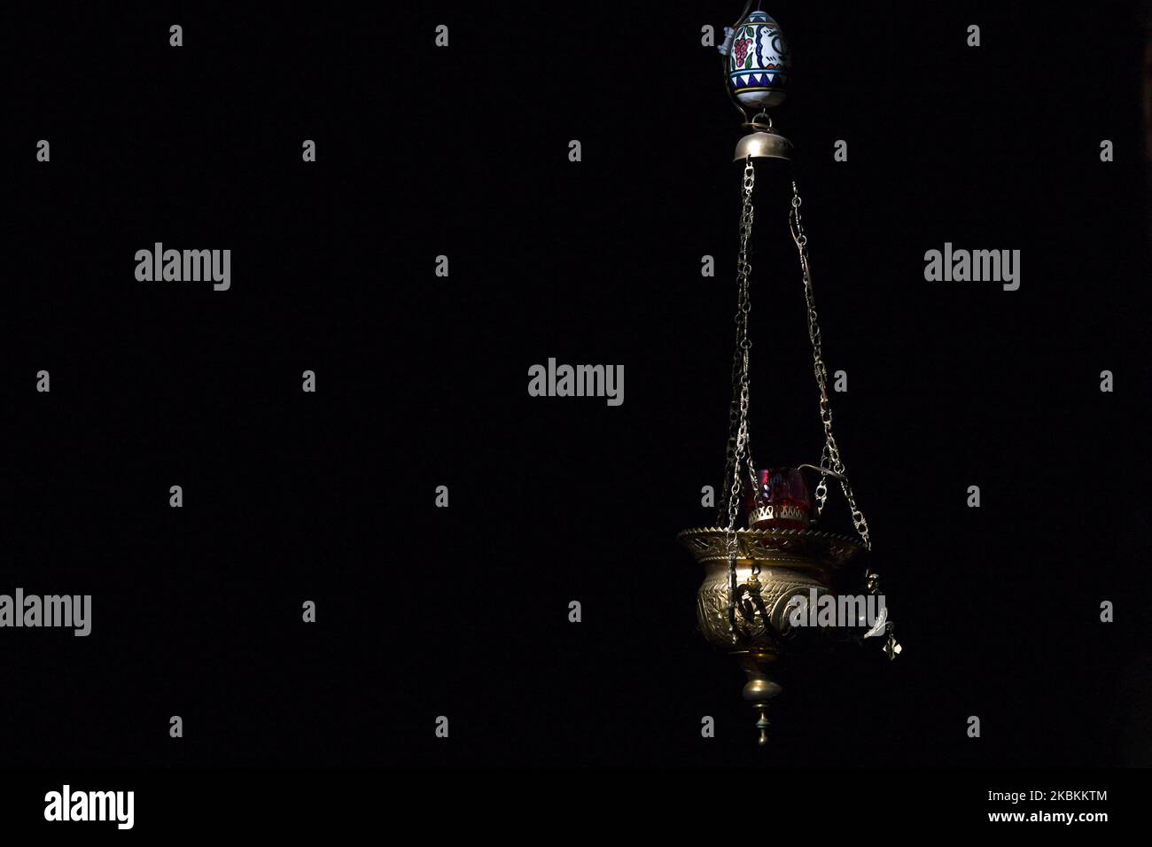 A sanctuary lamp seen inside an empty Church of the Nativity in ...