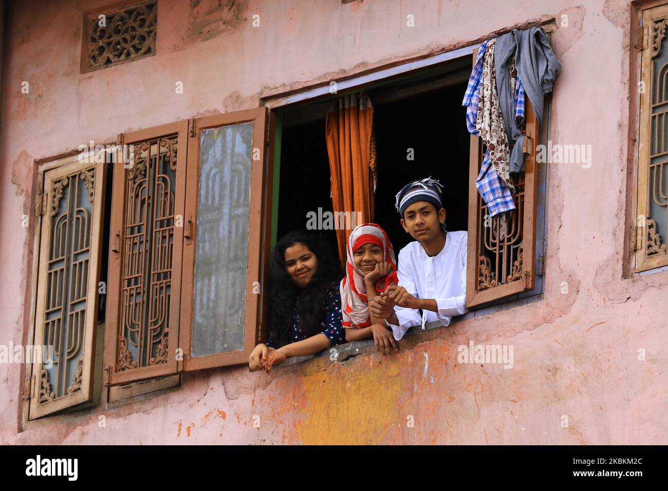 Kids look outside from their house during the Lockdown imposed in the ...