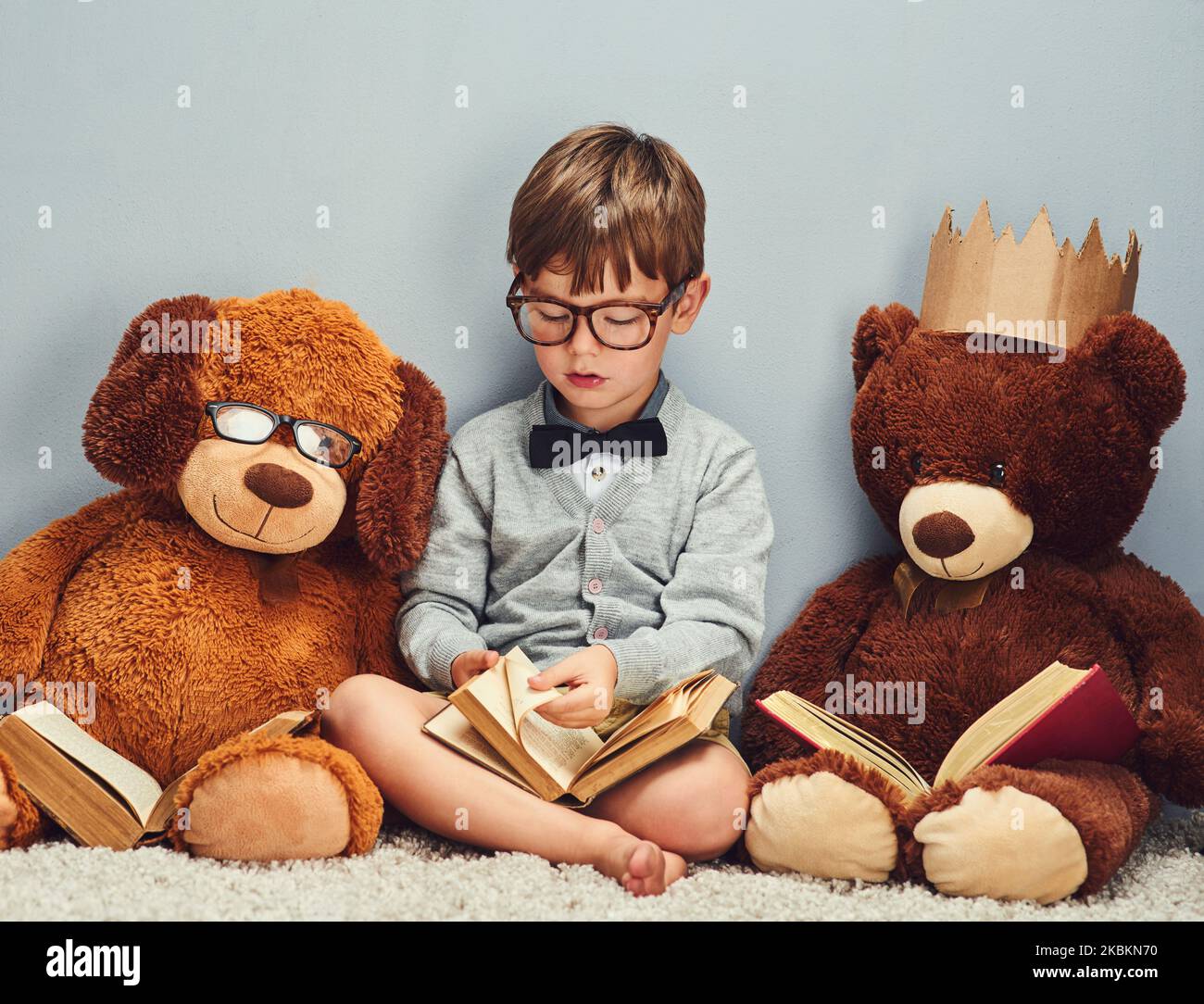 Everybody needs a cool study buddy. Studio shot of a smart little boy ...