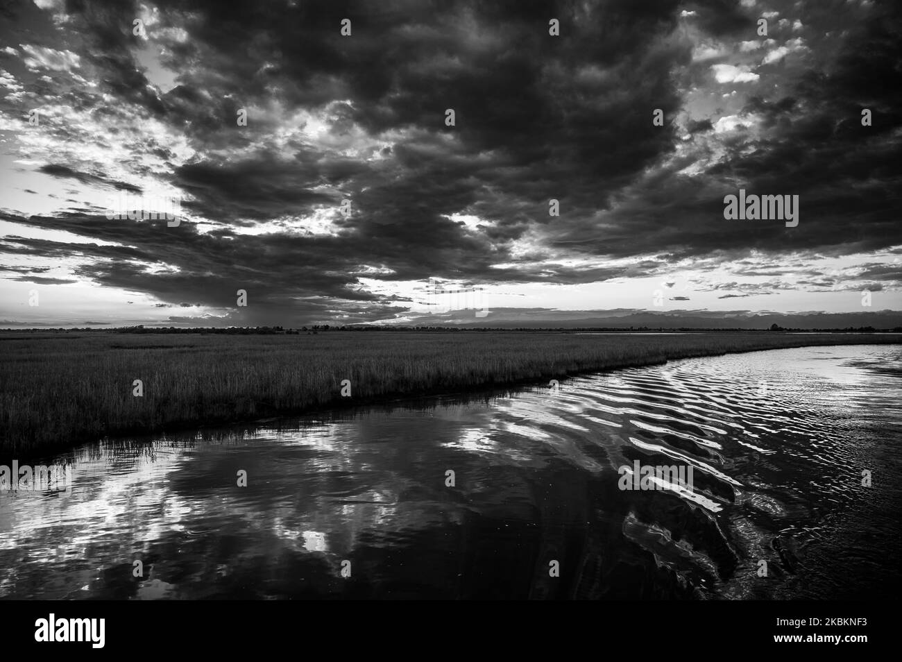 Towards the sunset. Marano lagoon late summer colors. Clouds and sun ...