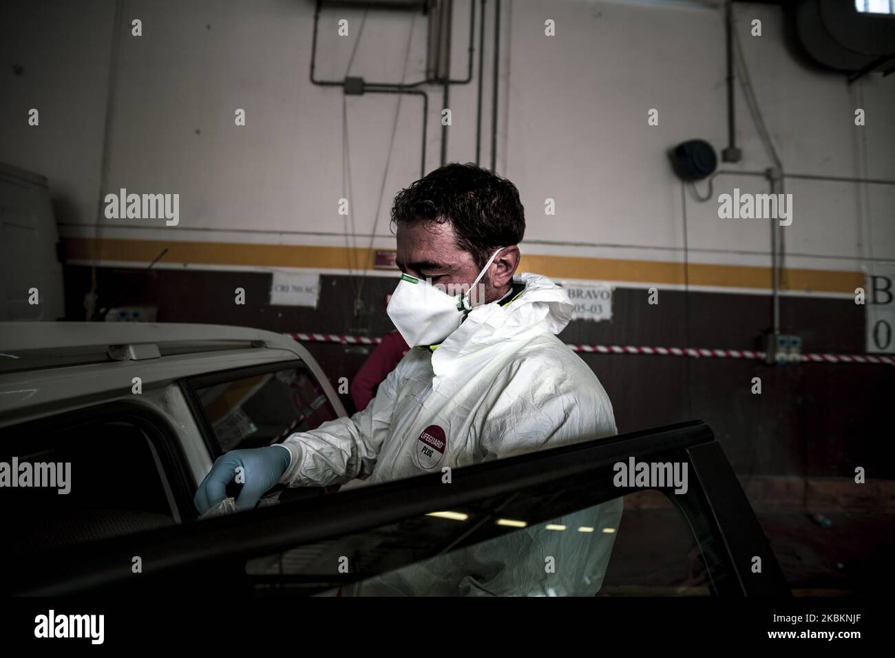 A doctor from 118 with Red Cross team visiting at home suspect cases of ...