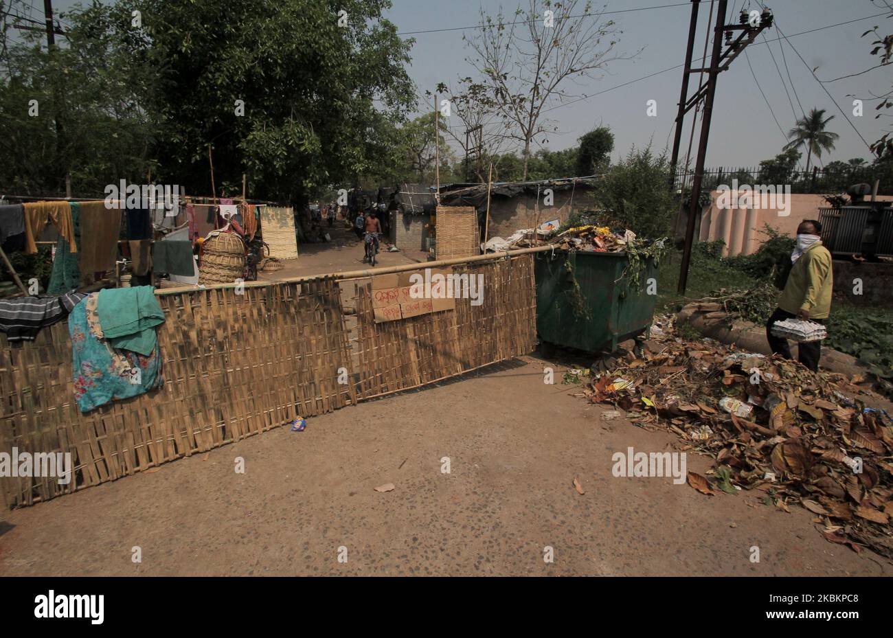 Slum dwellers are seen at their living slum entry gate as they blocked ...