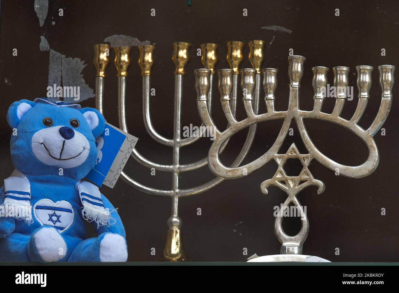 A Teddy Bear in Israeli colors and two examples Menorah seen in a shop ...