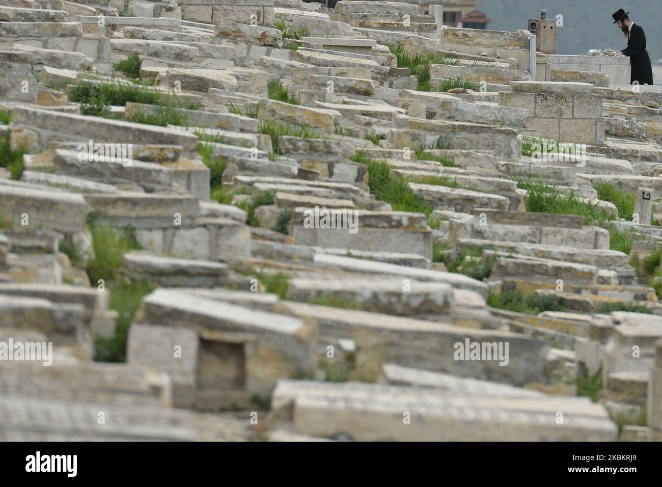 An Orthodox Jew seen praying at the main Jewish graveyard in Jerusalem ...
