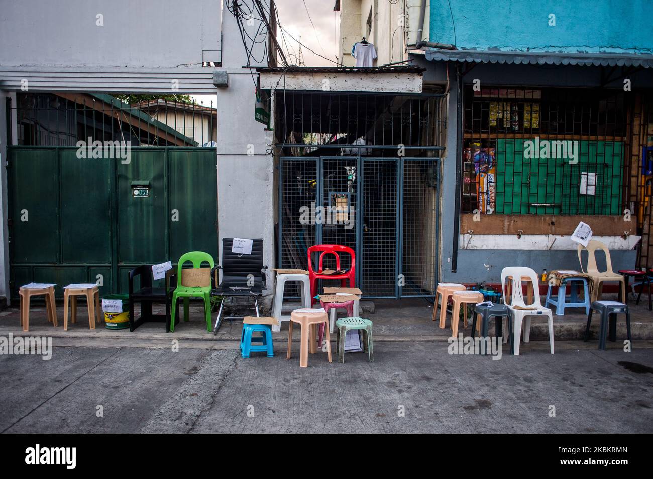Chairs bearing the names of residents are placed along the street to ...