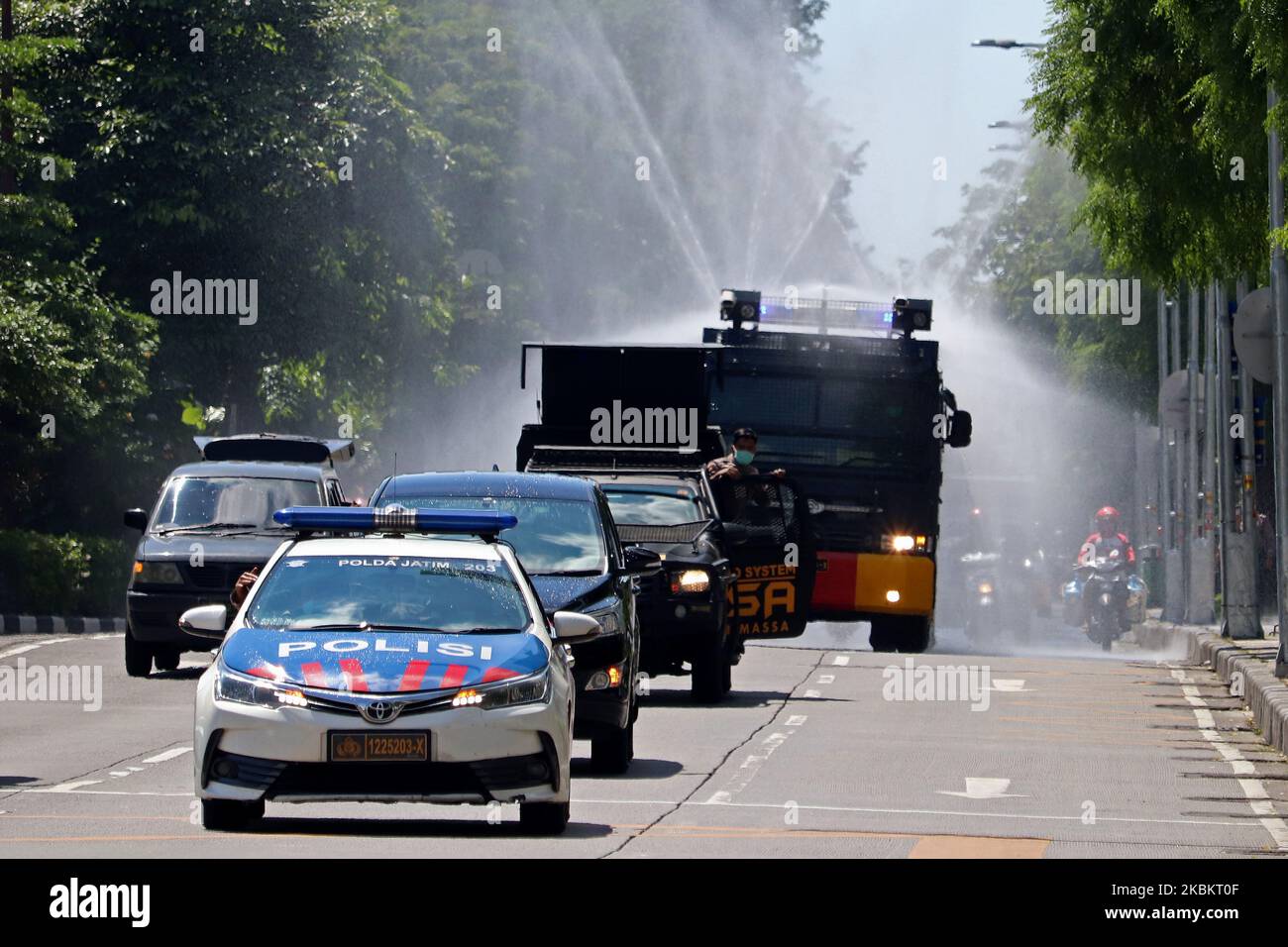 Indonesian police riot control vehicle sprays disinfectant hi-res stock ...