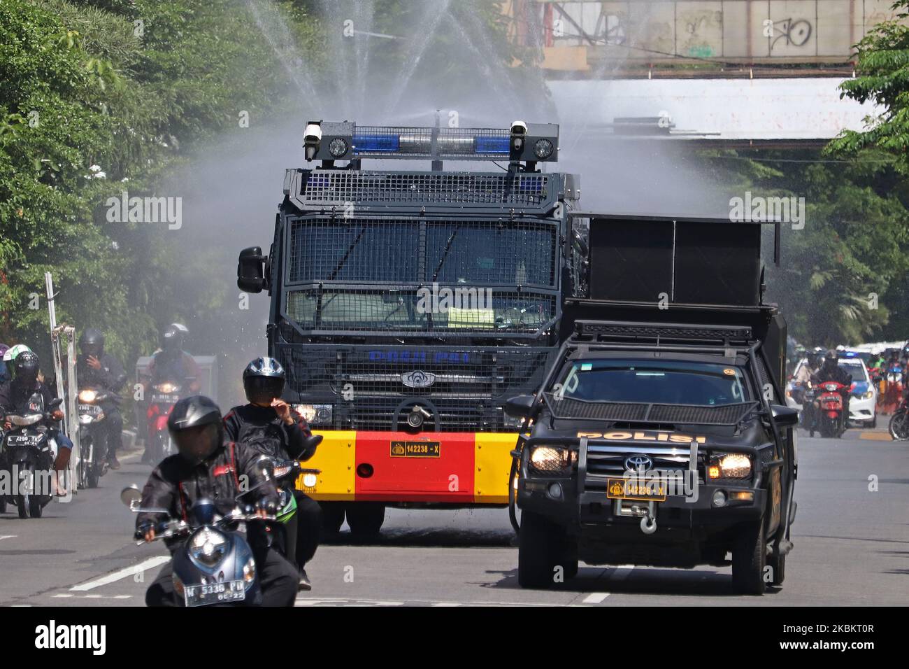 Indonesian police riot control vehicle sprays disinfectant hi-res stock ...