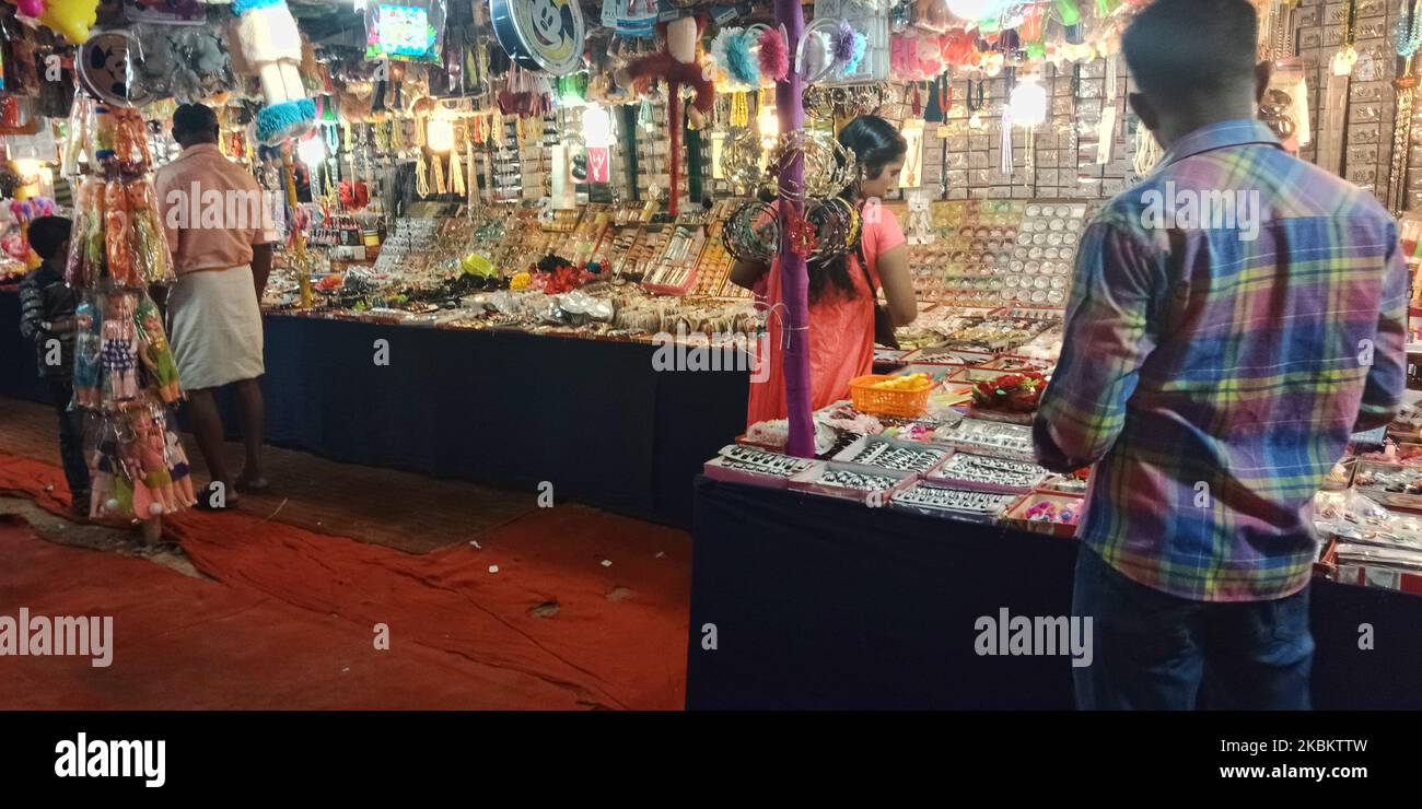 People shop for items at a market during the festival of Onam in ...