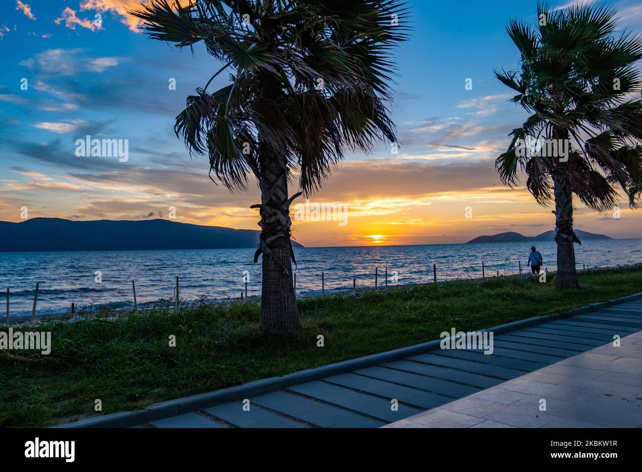 Sunset on the Adriatic Sea in the city of Vlore with palm trees and ...