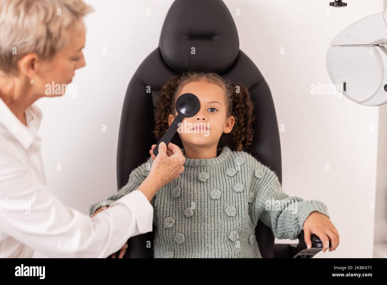 Eye exam, child and optometrist testing eye sight for glasses ...