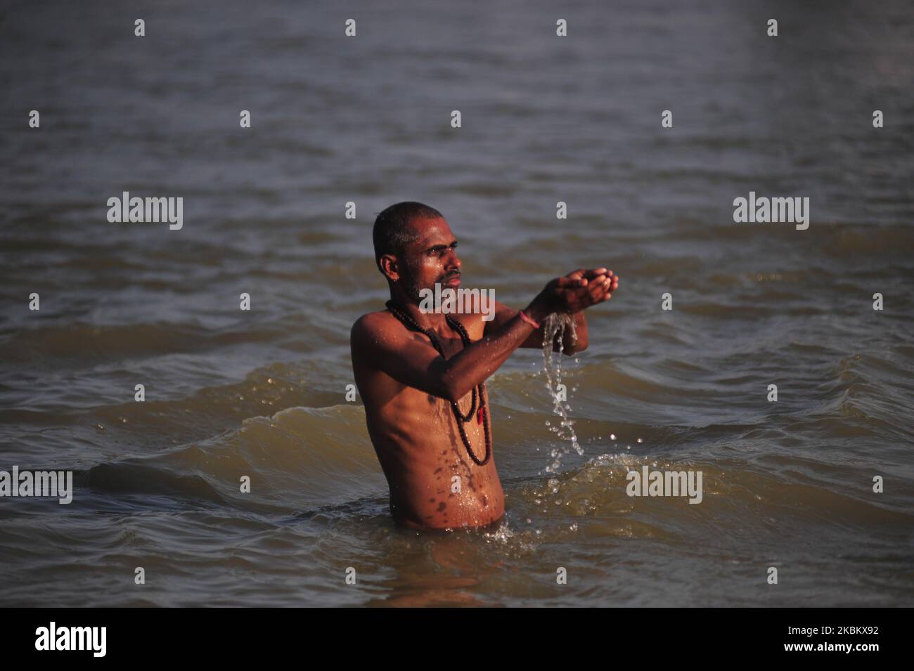 A man offers prayers at sangam, cofluence of ganges , Yamuna and ...