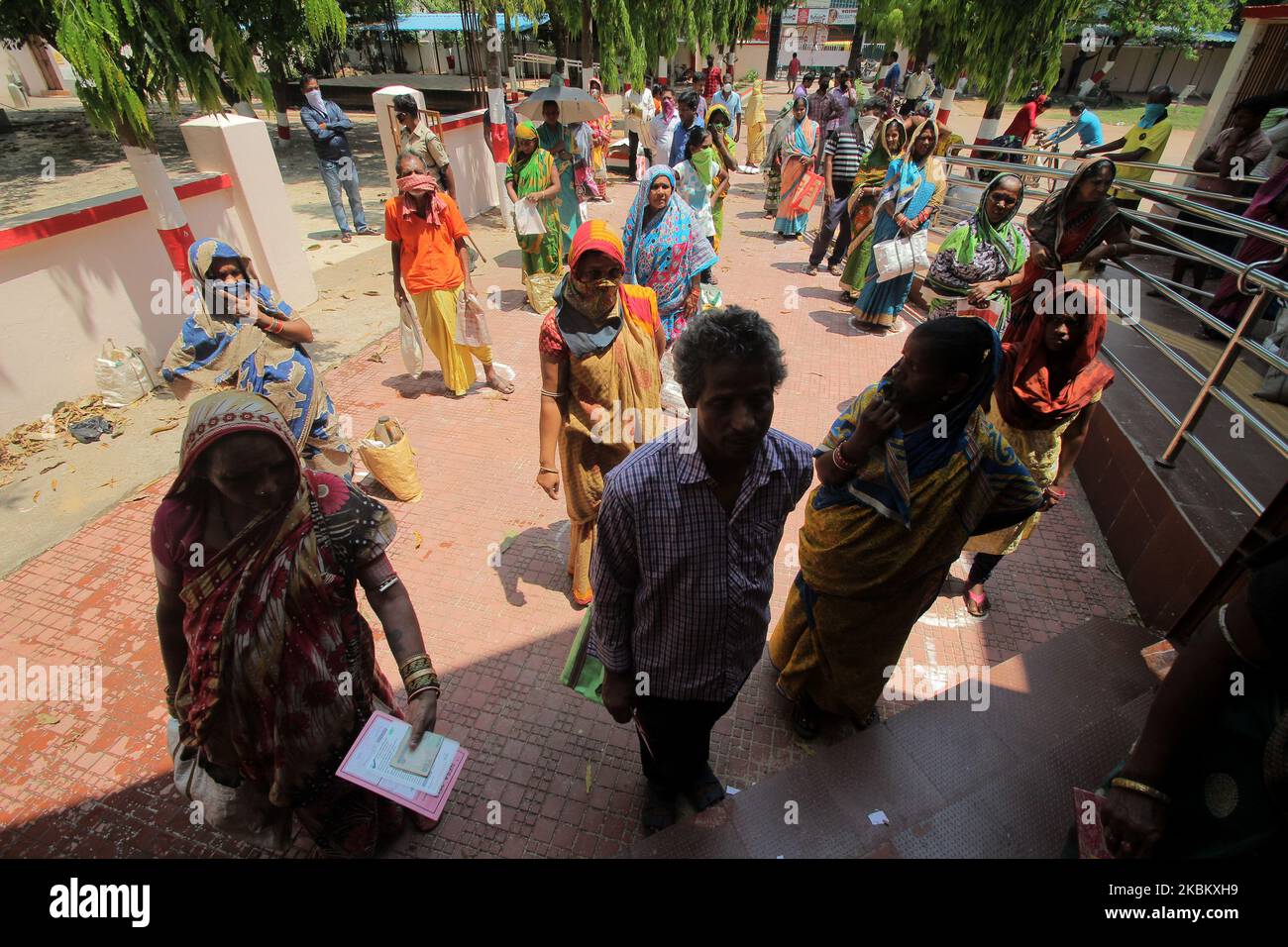 Below poverty line people stands in the queue as they are maintaing the ...