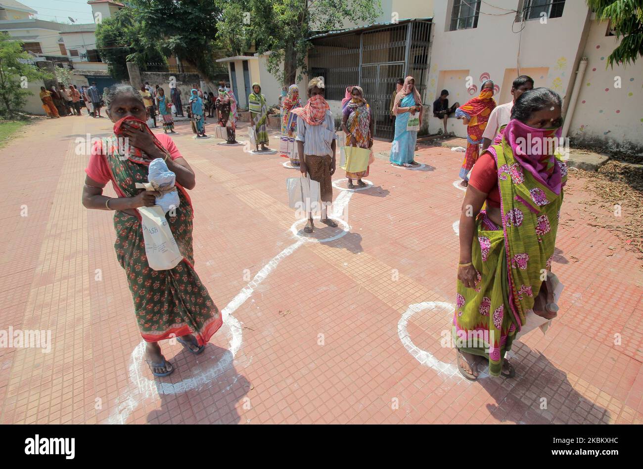 Below poverty line people stands in the queue as they are maintaing the ...