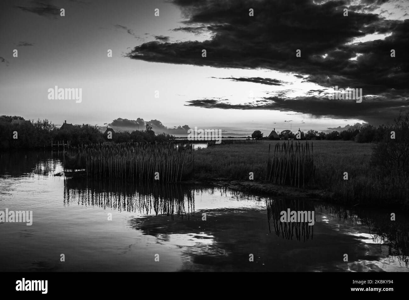 Towards the sunset. Marano lagoon late summer colors. Clouds and sun ...
