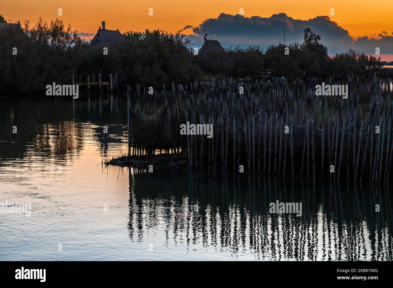 Towards the sunset. Marano lagoon late summer colors. Clouds and sun ...