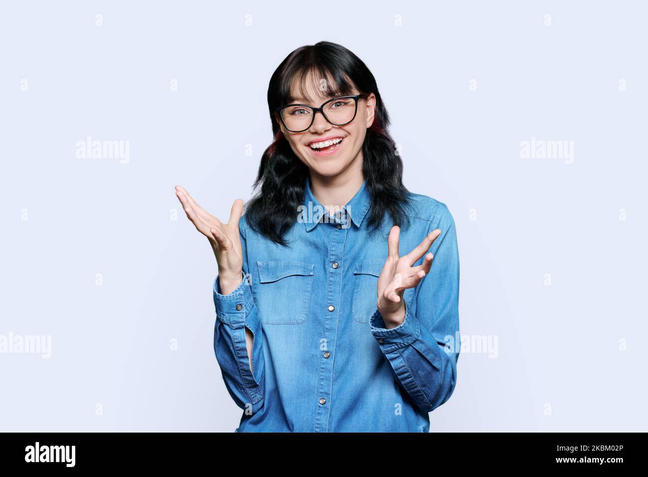 Emotional laughing young female student on white background Stock Photo ...