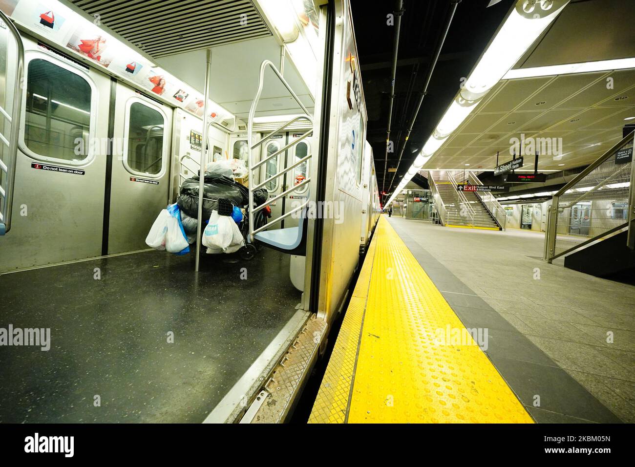 A homeless person takes shelter in a subway train AT Hudson Yards, New ...
