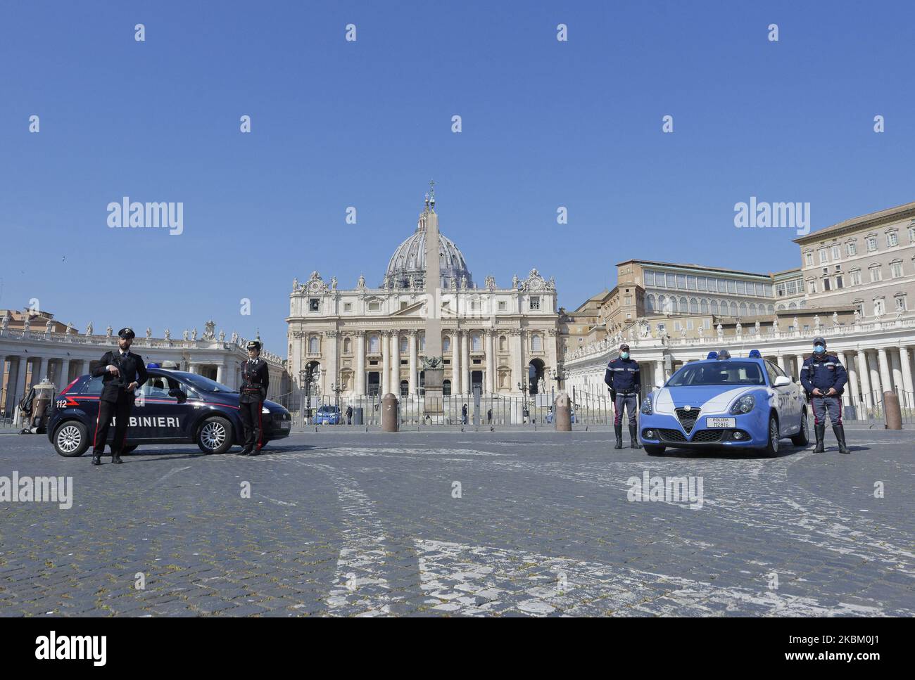 Italian police cars patrol the area outside an empty St.Peter's Square ...