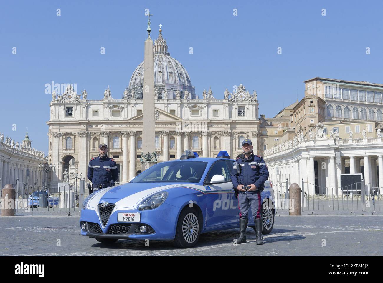 Italian police cars patrol the area outside an empty St.Peter's Square ...