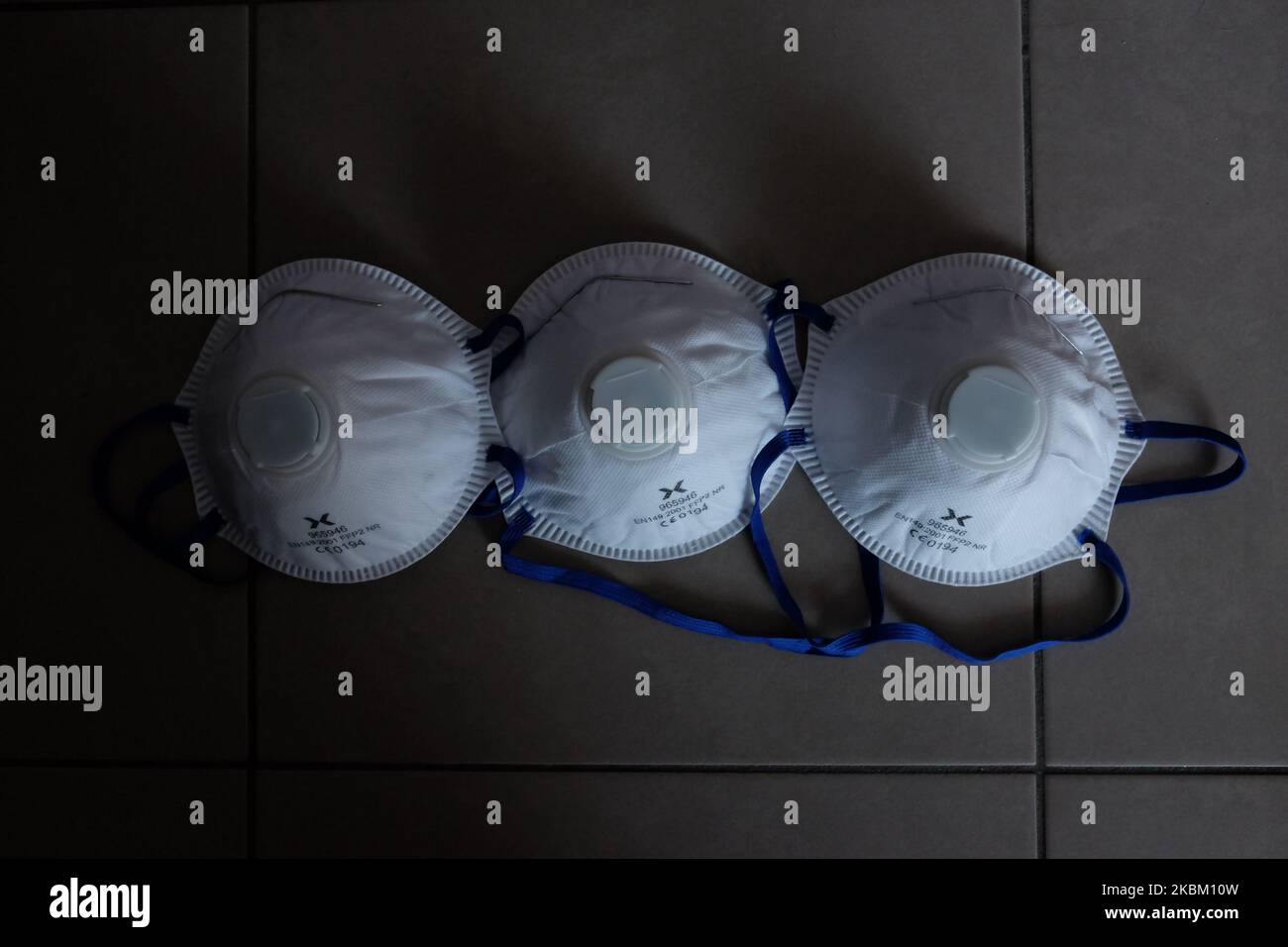 FFP2 masks are illustrated on the floor, Italy, April 2020. By a ...