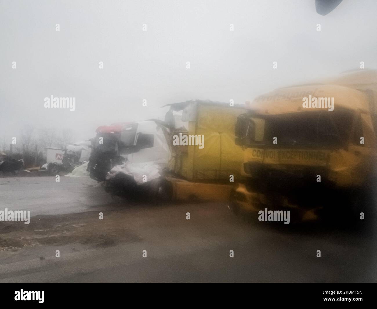 The remains of 22 heavy trucks that were part of a chain crash ...