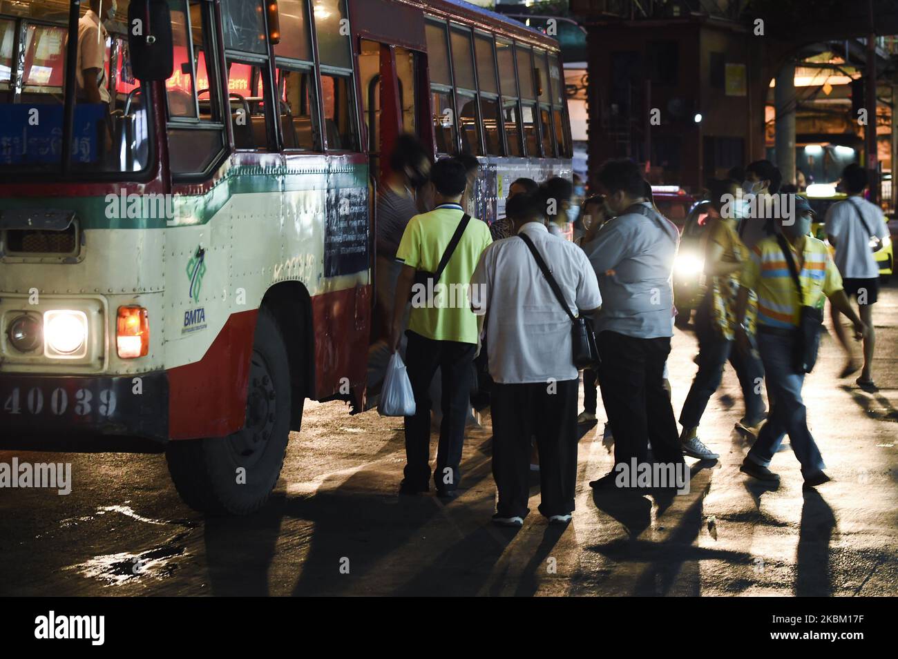 People board a public bus to head back home before starting curfew a ...