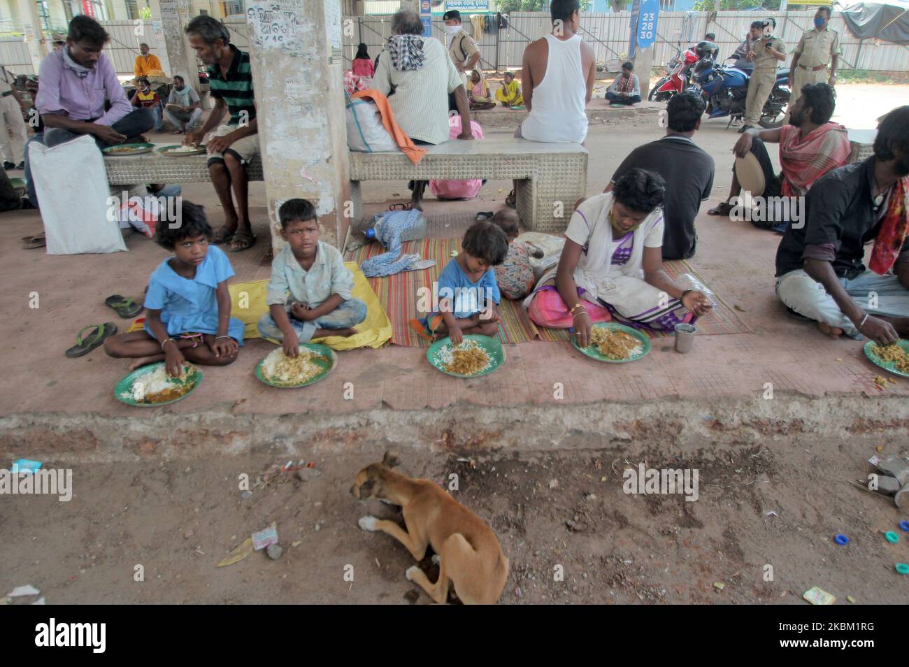 Destitute and homeless street living people having cooked food as it ...
